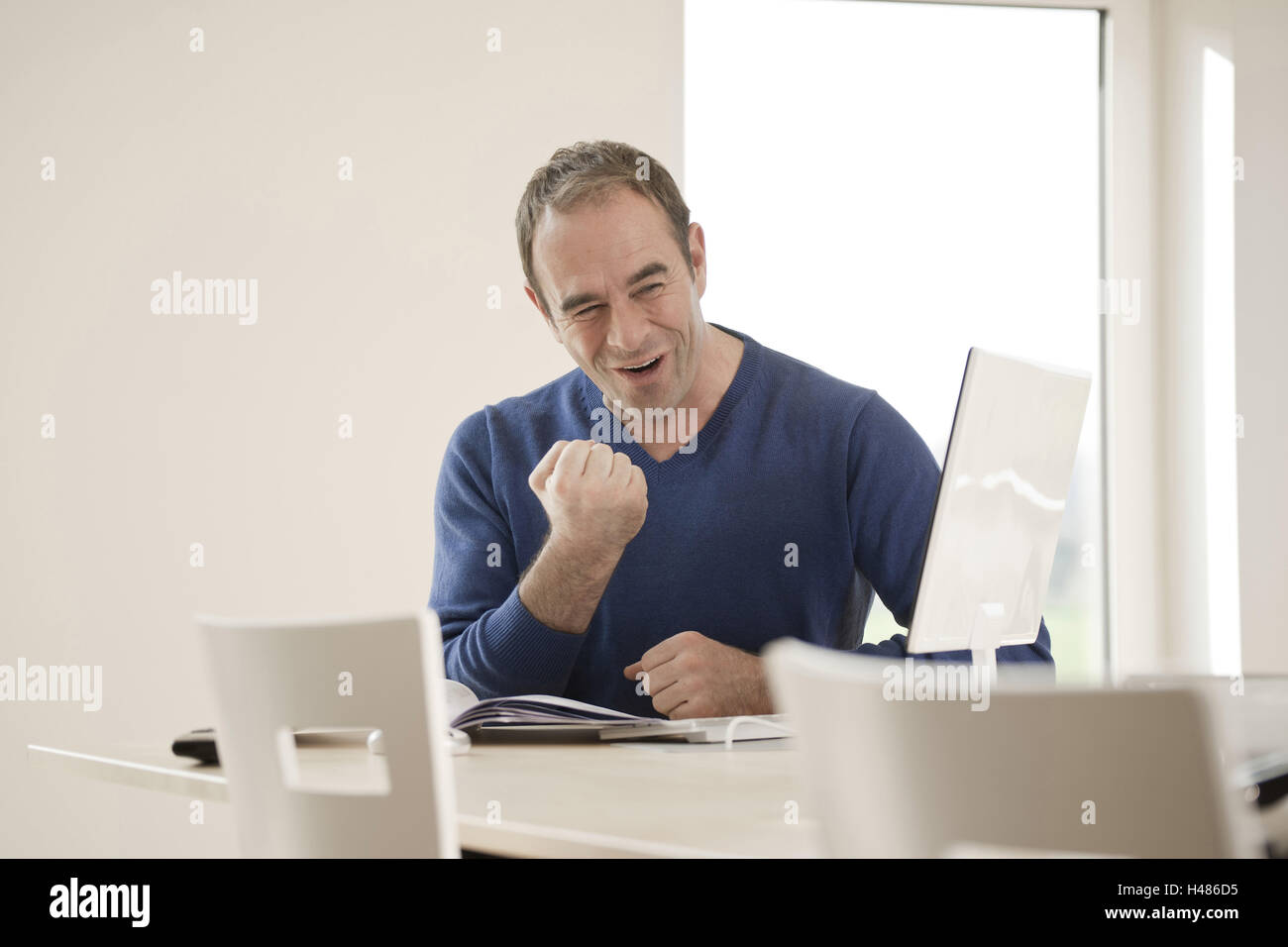Man sitting happy in front of the computer Stock Photo - Alamy