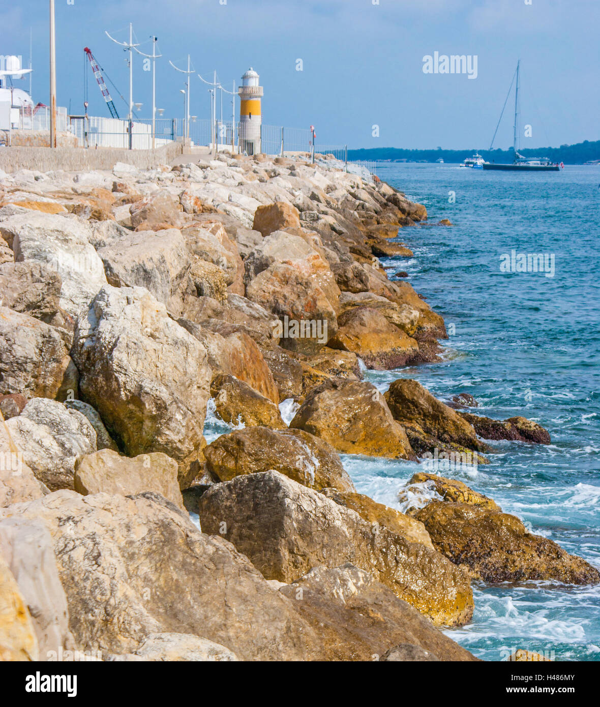 The view on the rocky shore of Cannes with a lighthouse on the ...