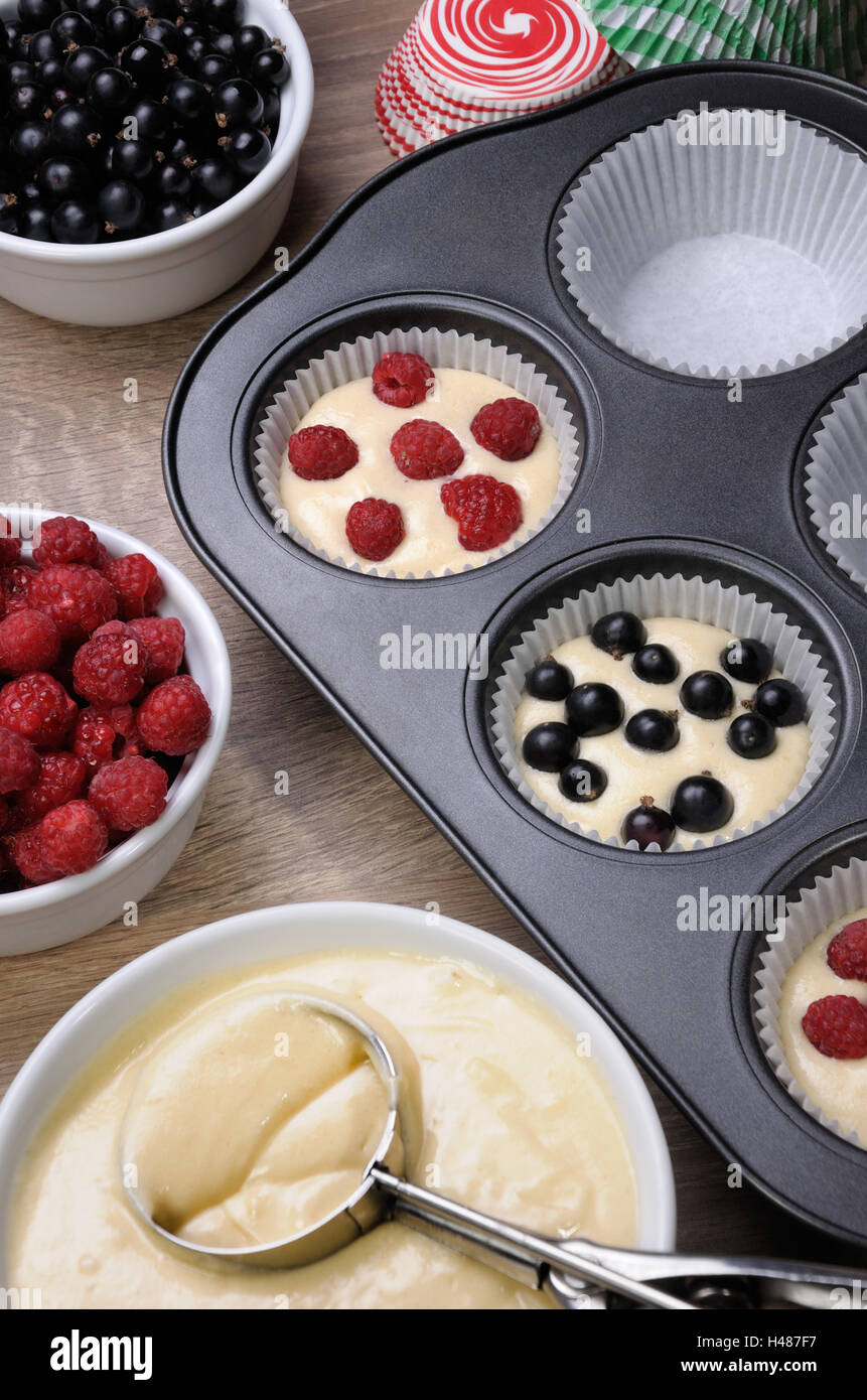 Preparation for baking muffins stuffed with raspberries and black ...