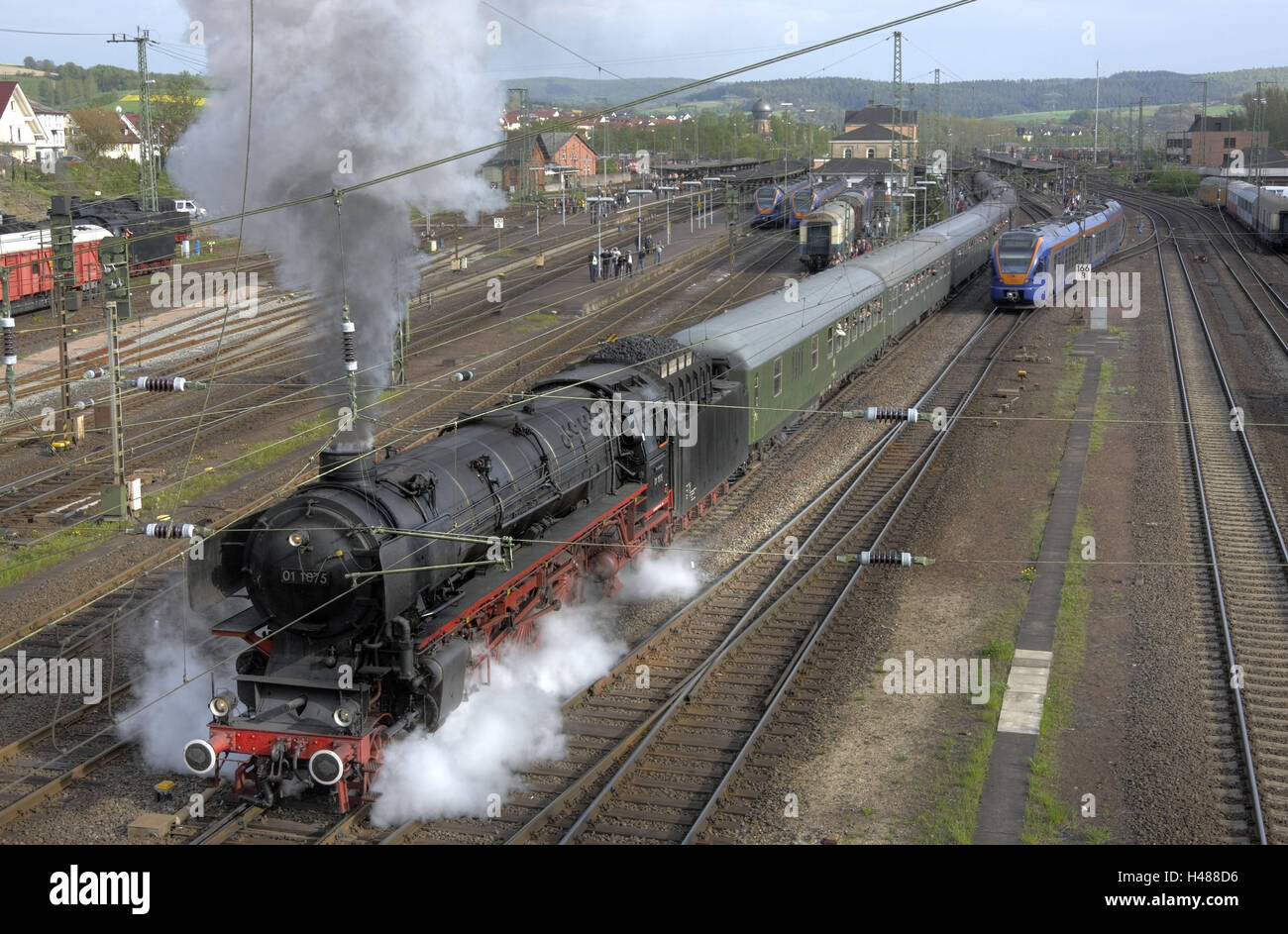 Railway station, passenger train, steam locomotive Stock Photo - Alamy