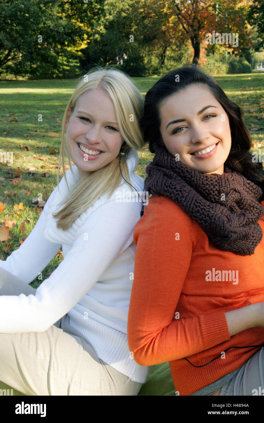Women, two, smiling, sitting, side view Stock Photo - Alamy