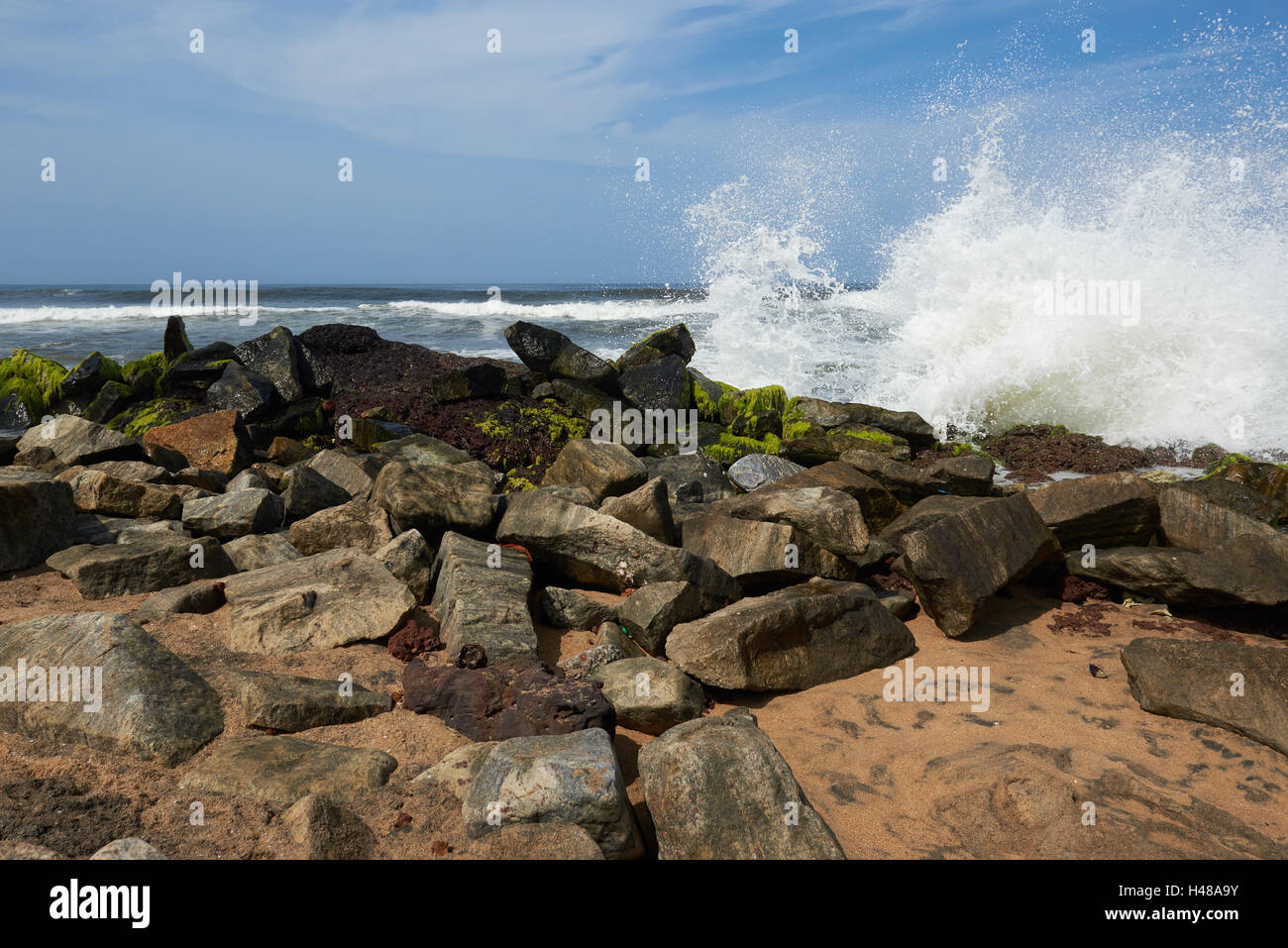 Waves pounding a rock strewn beach Stock Photo - Alamy