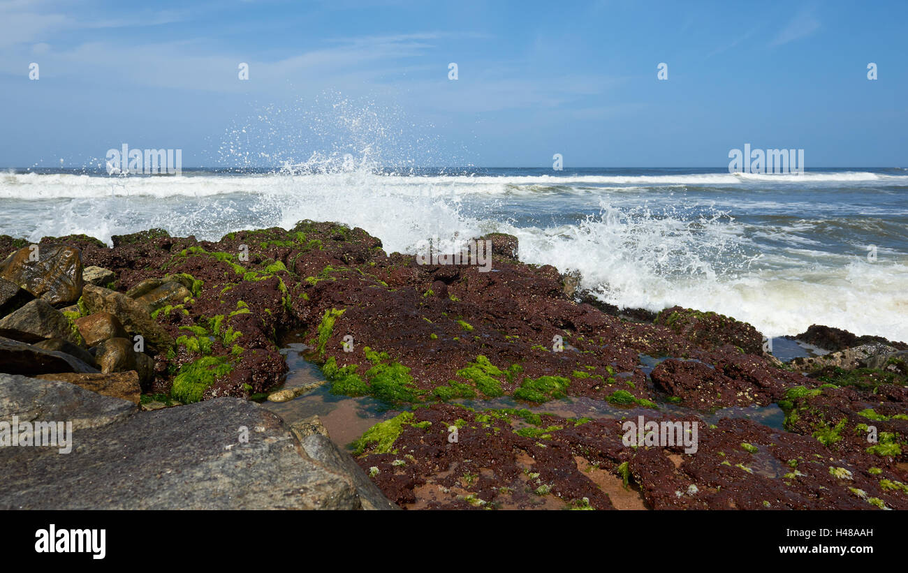 Waves pounding a rock strewn beach Stock Photo - Alamy