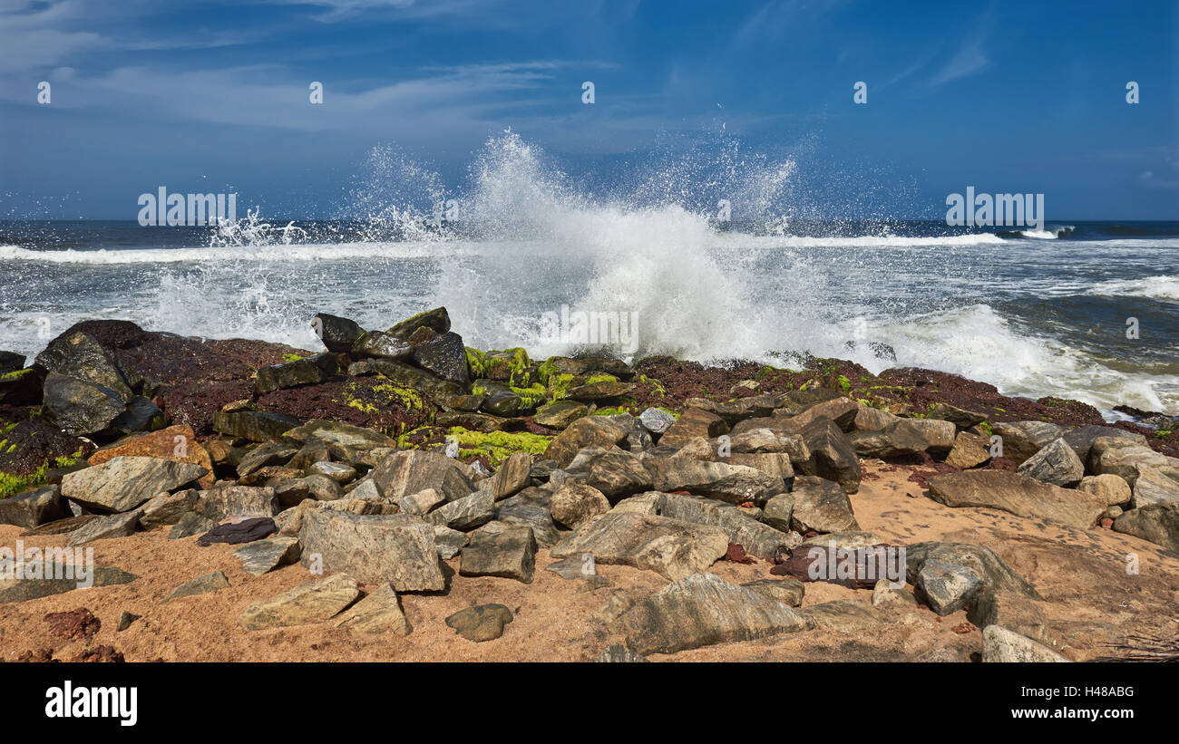 Waves pounding a rock strewn beach Stock Photo - Alamy