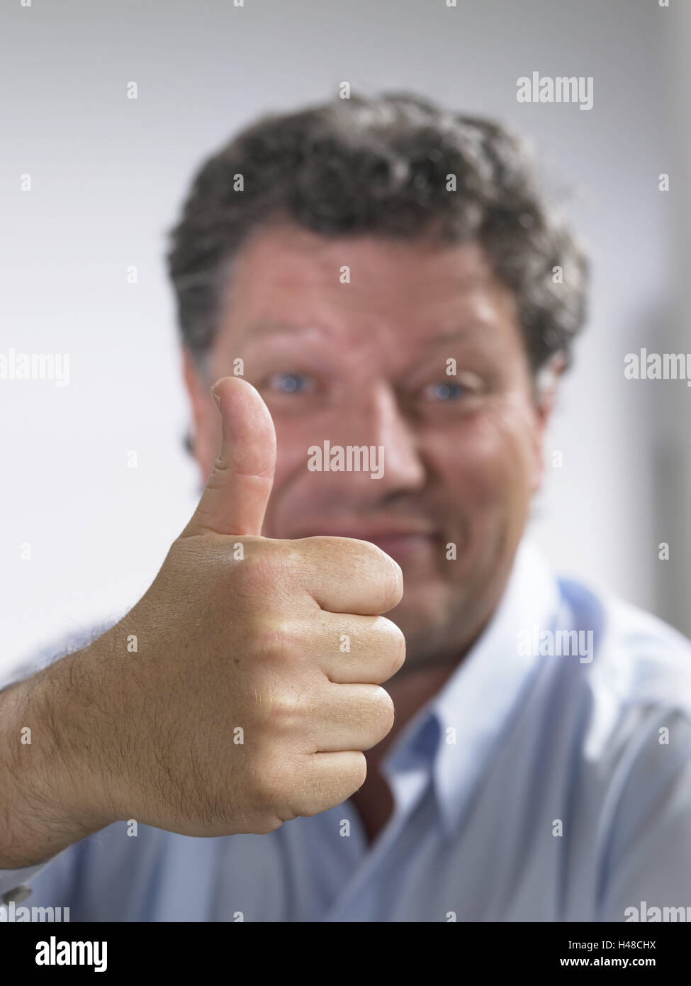 Man, view camera, smile, show pollex, gesture, detail, person, shirt ...