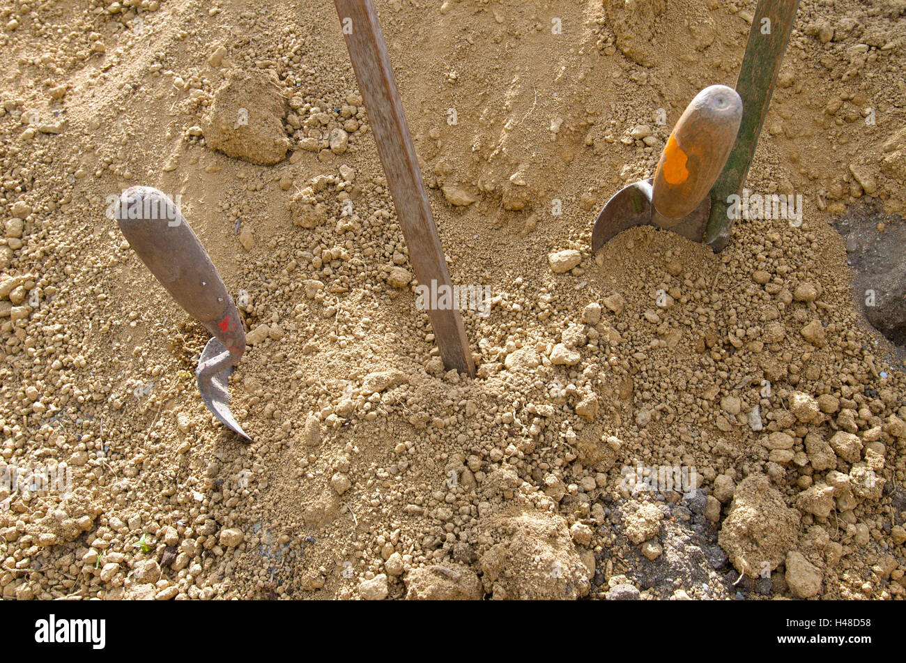Garden tools, hand-shovels in ground Stock Photo - Alamy