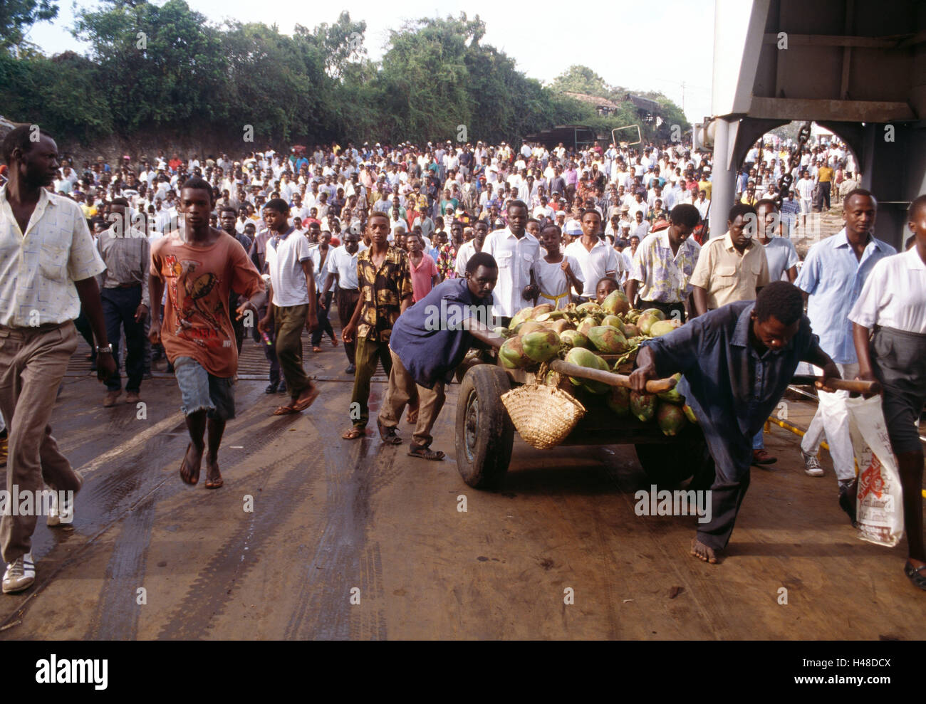 Africa, Kenya, crowd people, men, carriages, drag, coconuts, East ...