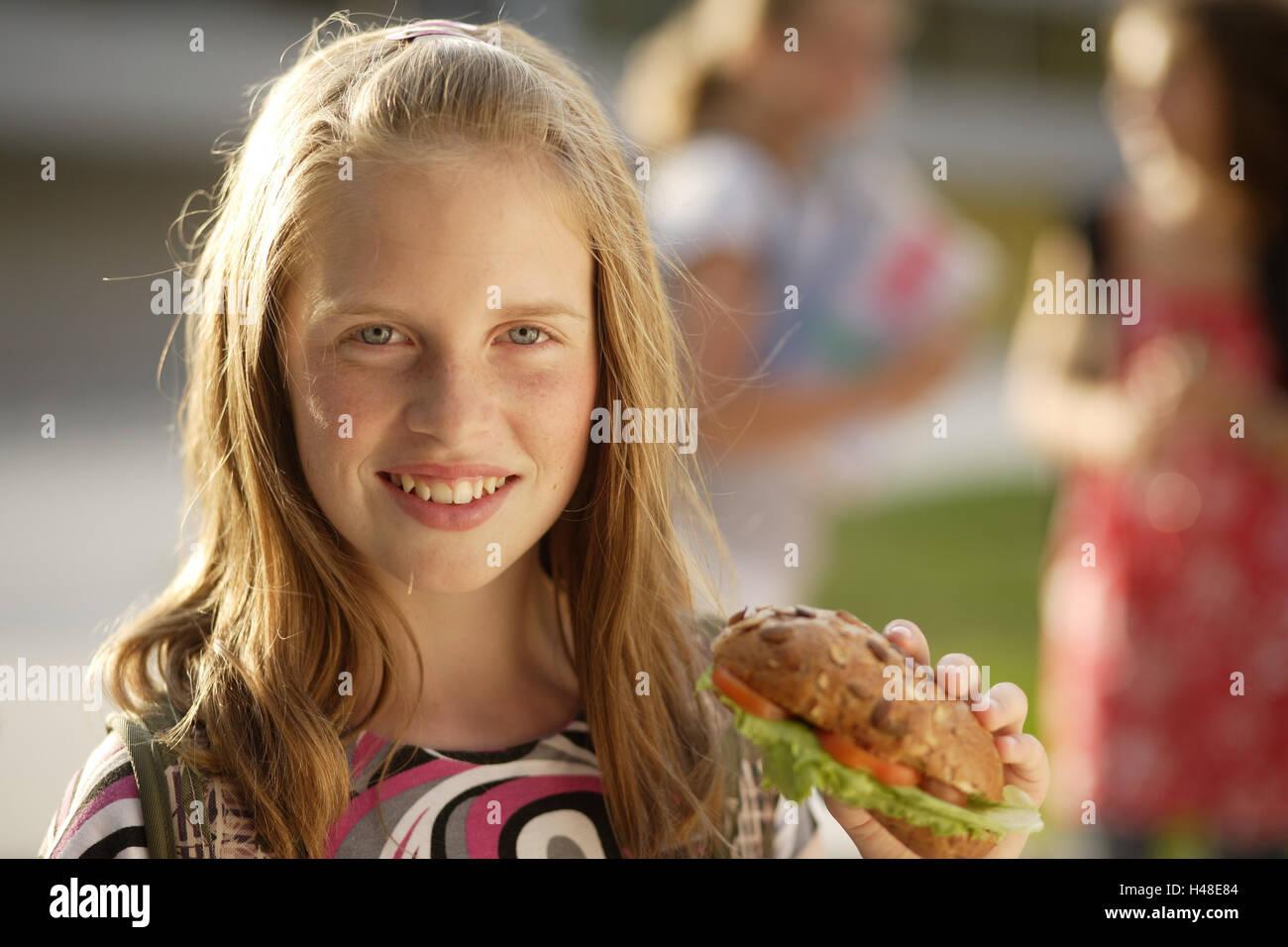 Girls, bread rolls, playground, view camera, portrait Stock Photo - Alamy