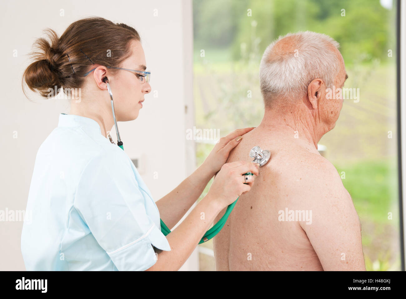 Boss is examined by young doctor Stock Photo - Alamy