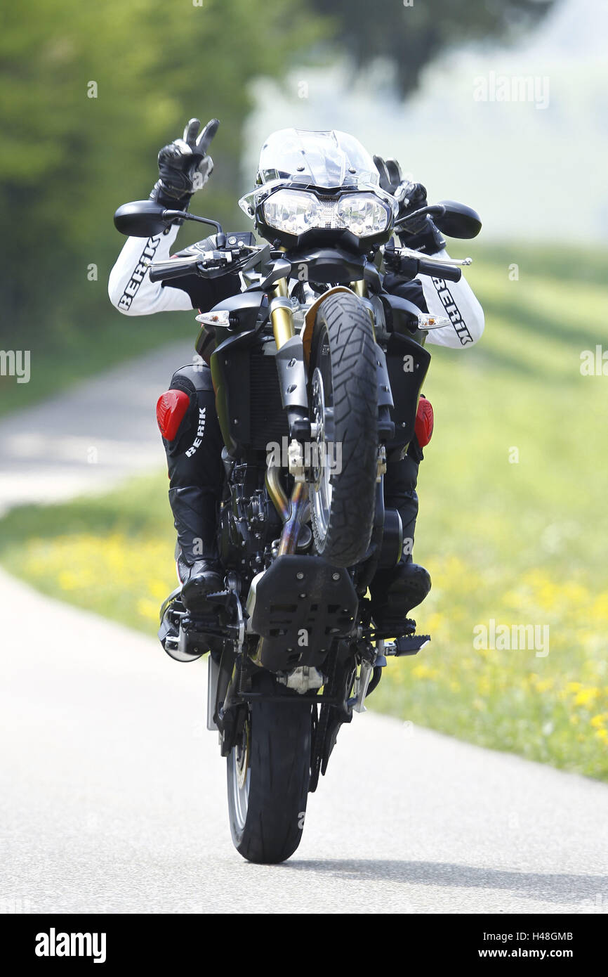 Country road, motorcycle, motorcyclist, wheelie, dynamic, head-on, no ...