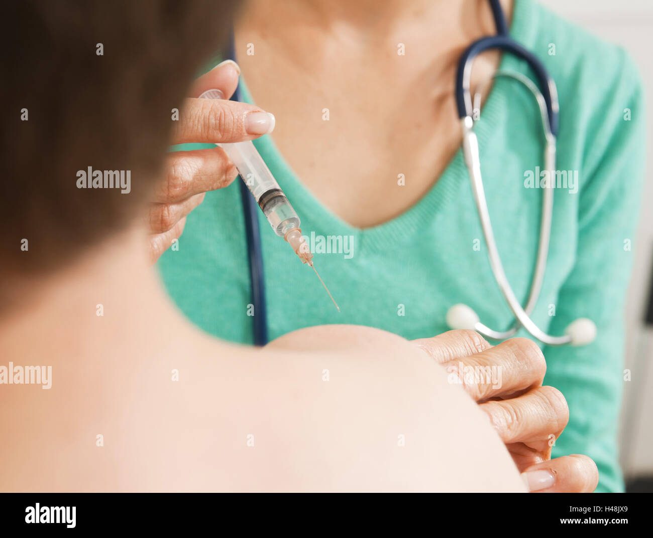 Teenager receives an injection Stock Photo - Alamy