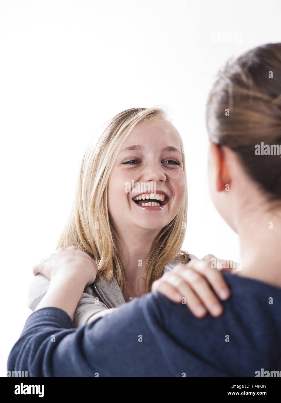 Teenage girls, eye contact, laugh, fun, studio Stock Photo - Alamy