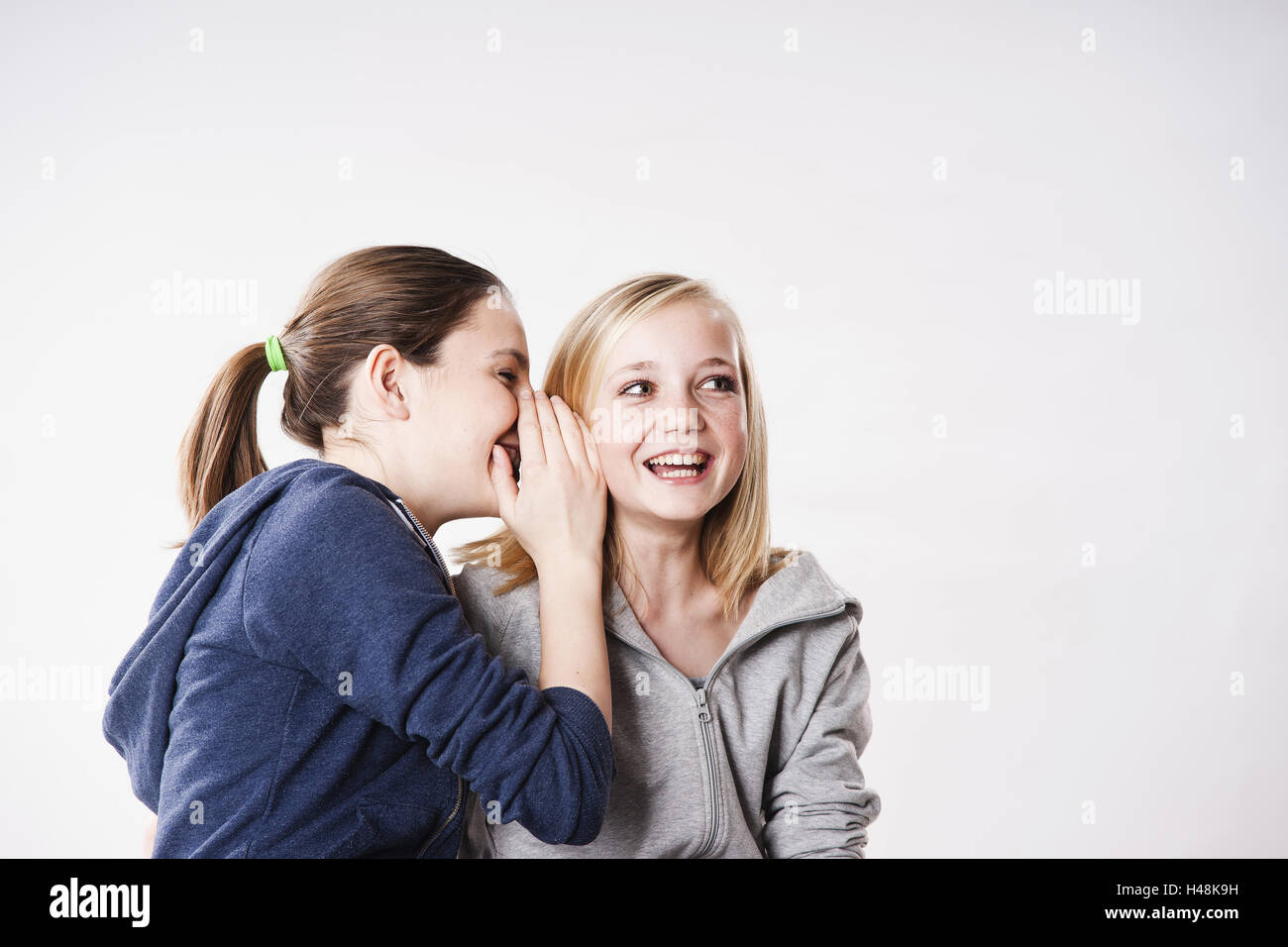 Two teen girls whispering hi-res stock photography and images - Alamy