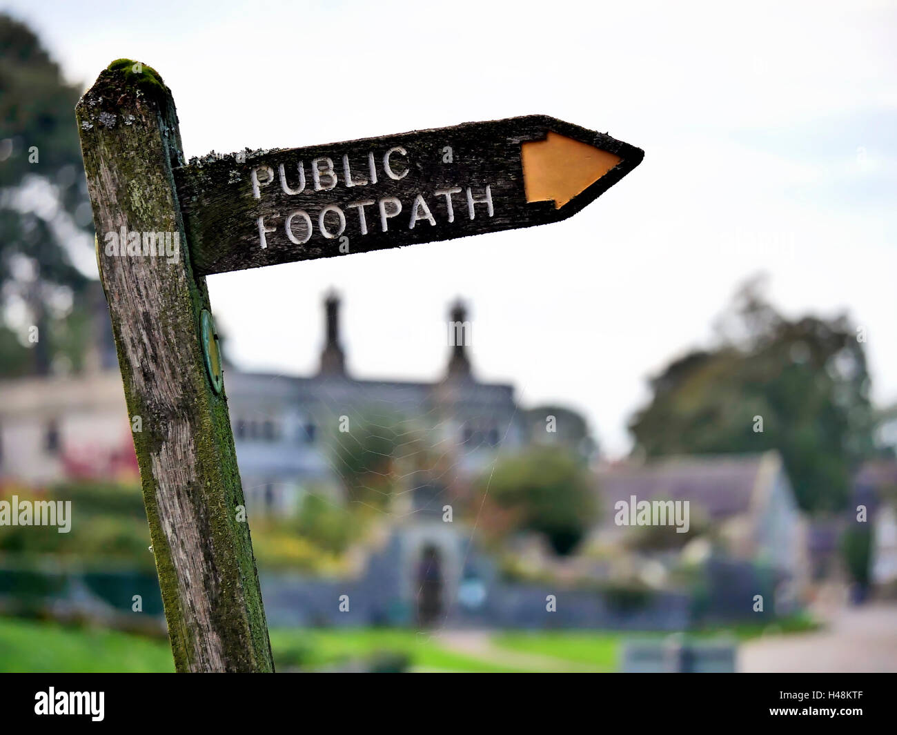 Public Footpath walkers signpost in Tissington with Tissington Hall in ...