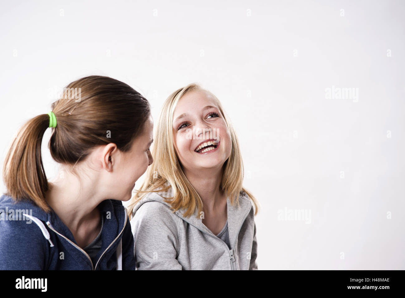 Teenage girls, two, conversation, laugh, side view Stock Photo - Alamy