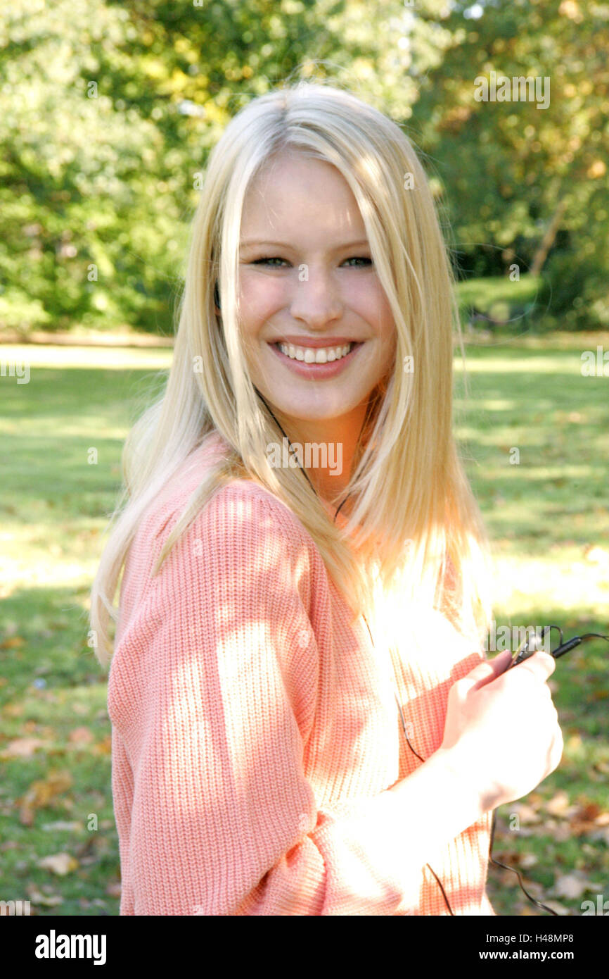 Woman, smiling, portrait, listening to music, side view Stock Photo - Alamy