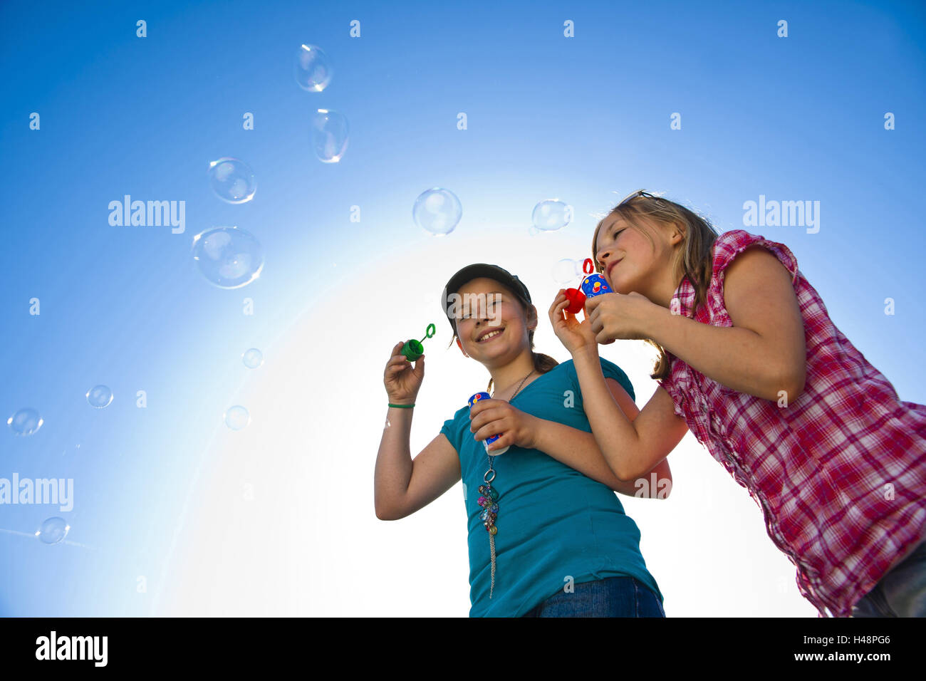 Two girls puff soap bubbles hi-res stock photography and images - Alamy