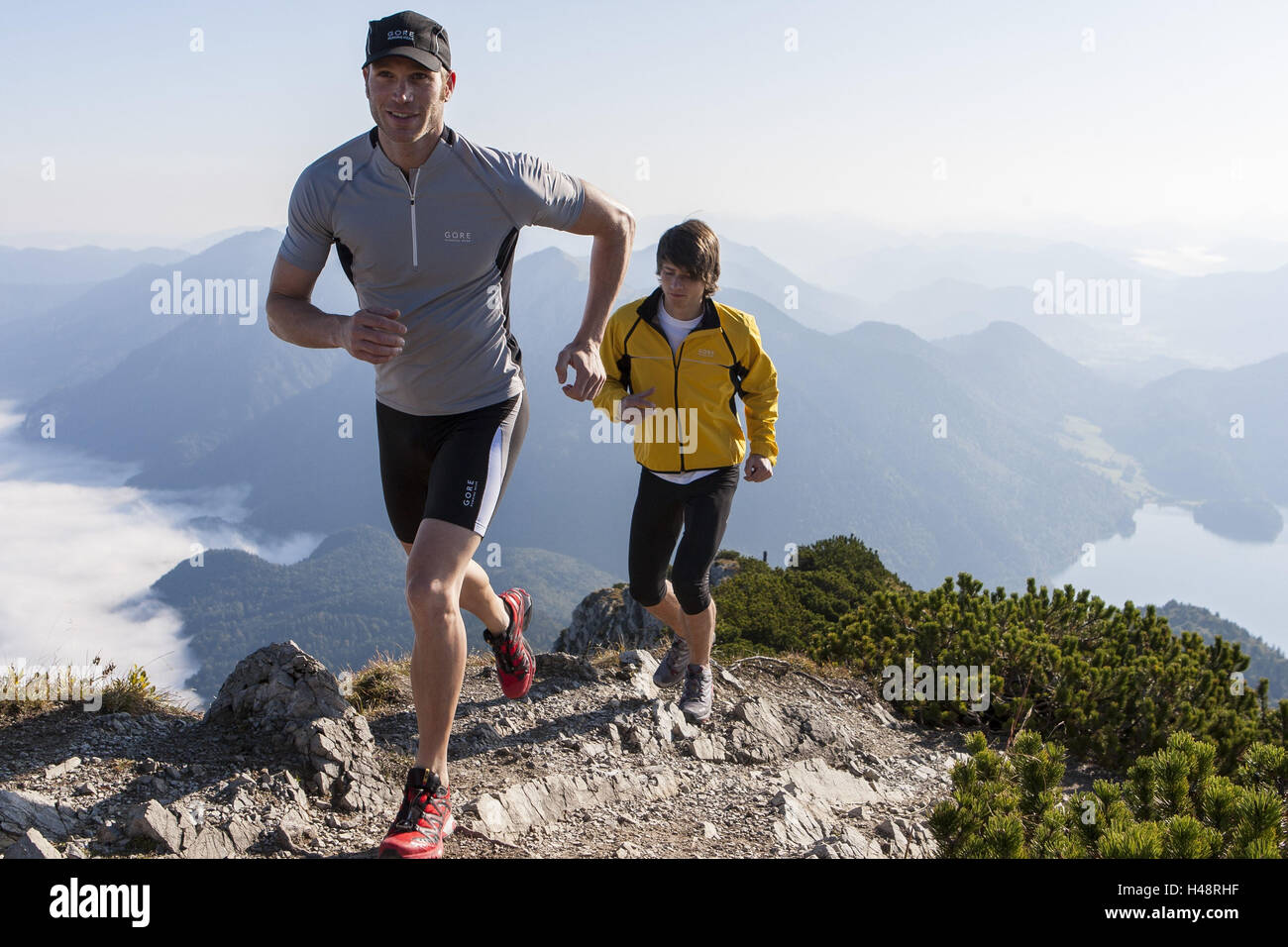 Two young mountain runners on mountain path Stock Photo - Alamy