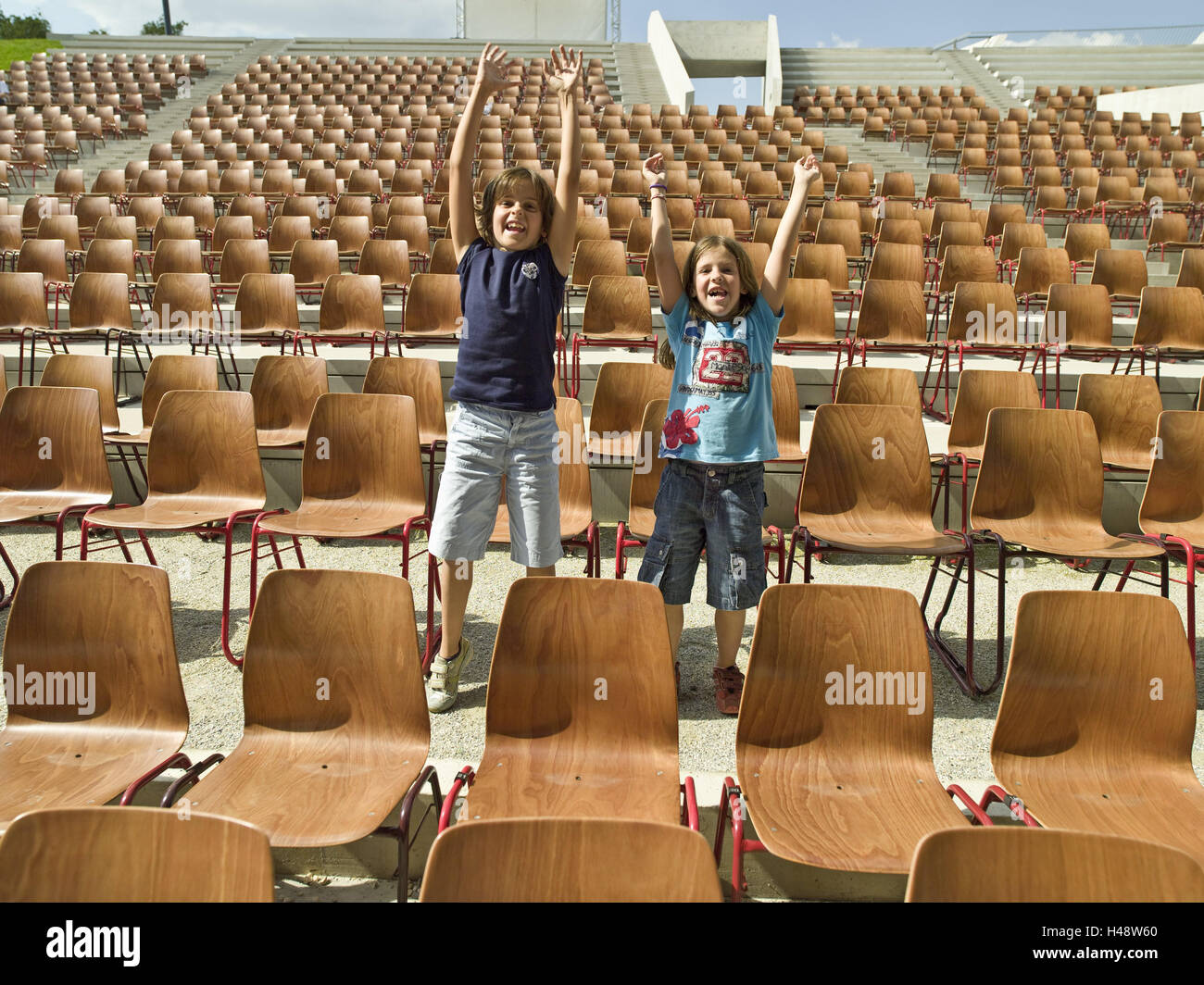 Children, two, open-air stage, chairs, stand, cheering Stock Photo - Alamy