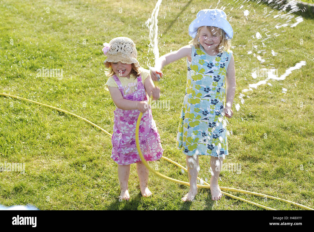Children, garden, water hose, play, splash Stock Photo - Alamy