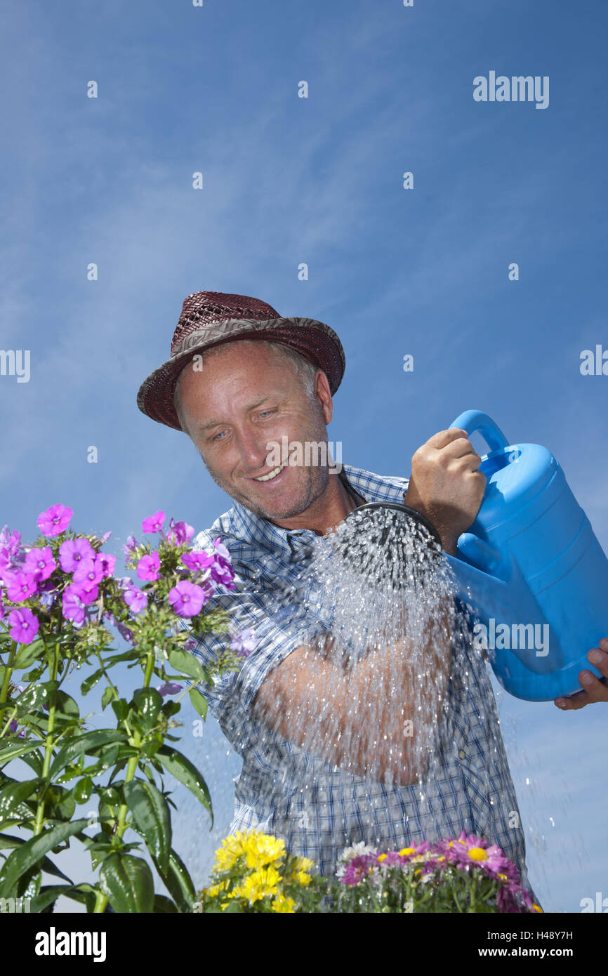 Man watering flowers Stock Photo - Alamy