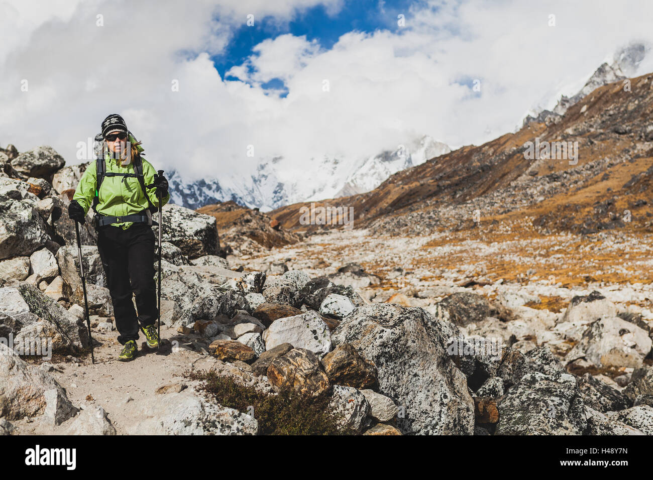 Woman hiker trekking with big backpack in Himalaya Mountains on Rocky ...