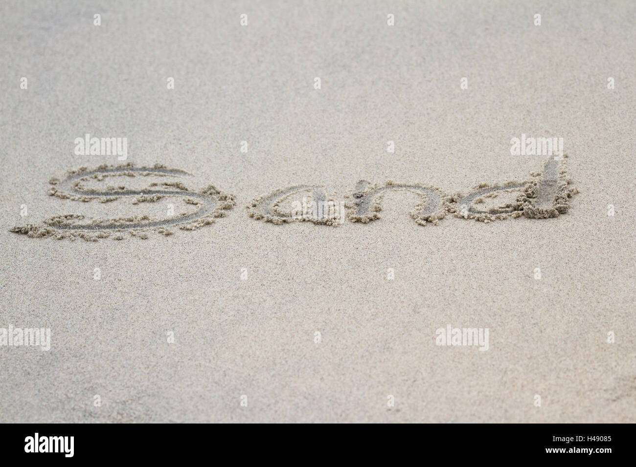 the word sand written on sand in a tropical beach Stock Photo - Alamy