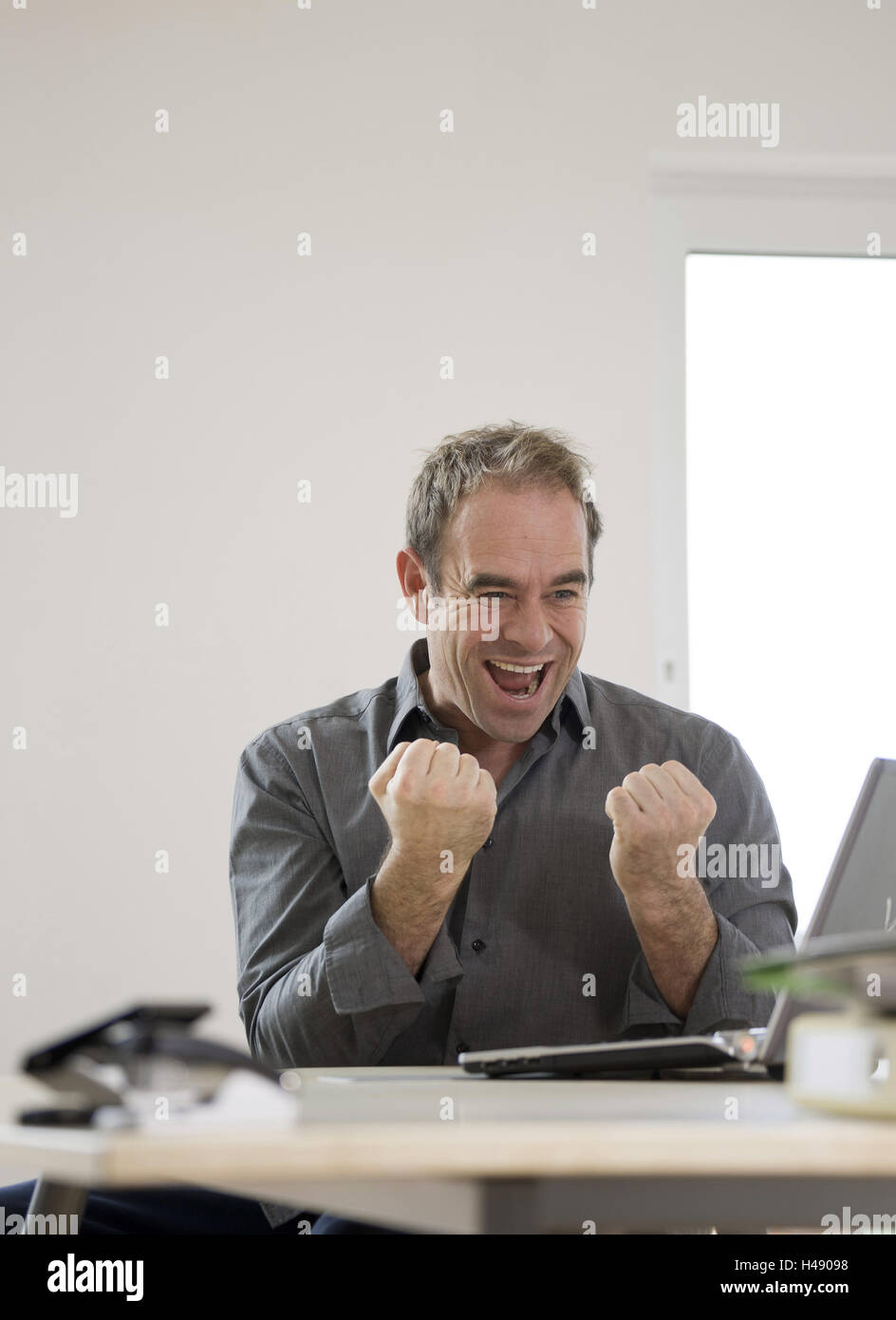 Man, happy in front of his Laptop Stock Photo - Alamy