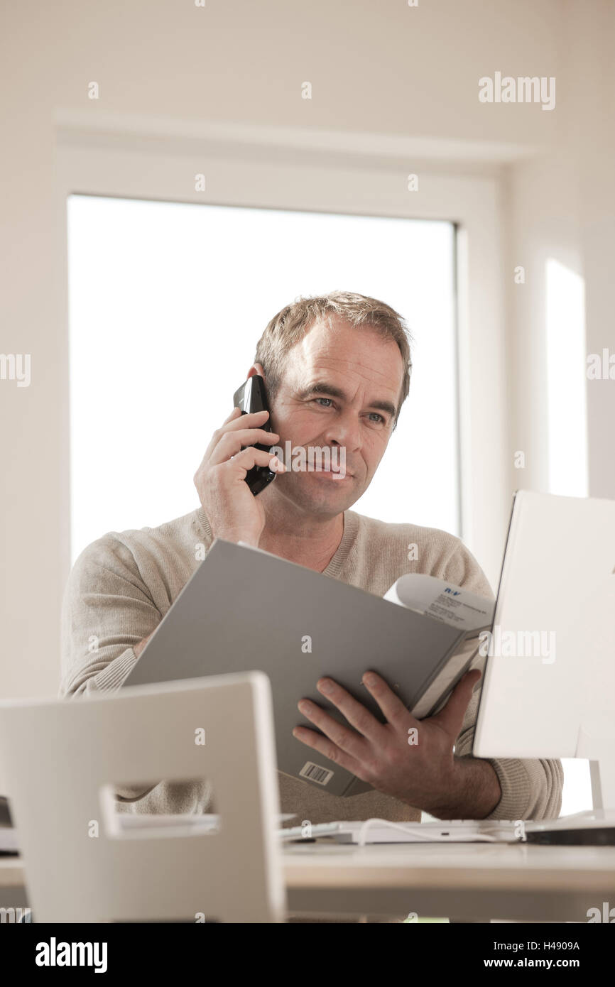 Man sits calling up before his computer Stock Photo - Alamy