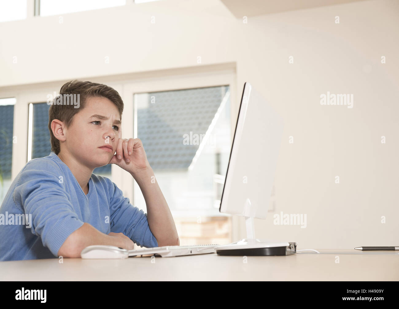 Boy works intently on the computer Stock Photo - Alamy