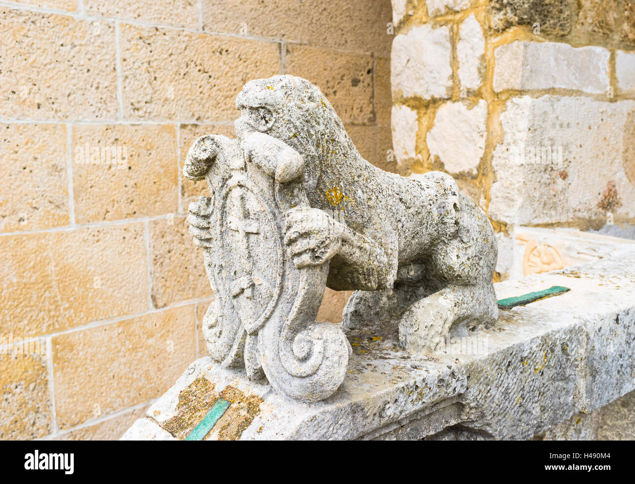 The statue of a lion holds the coat of arms in its clutches and guards ...