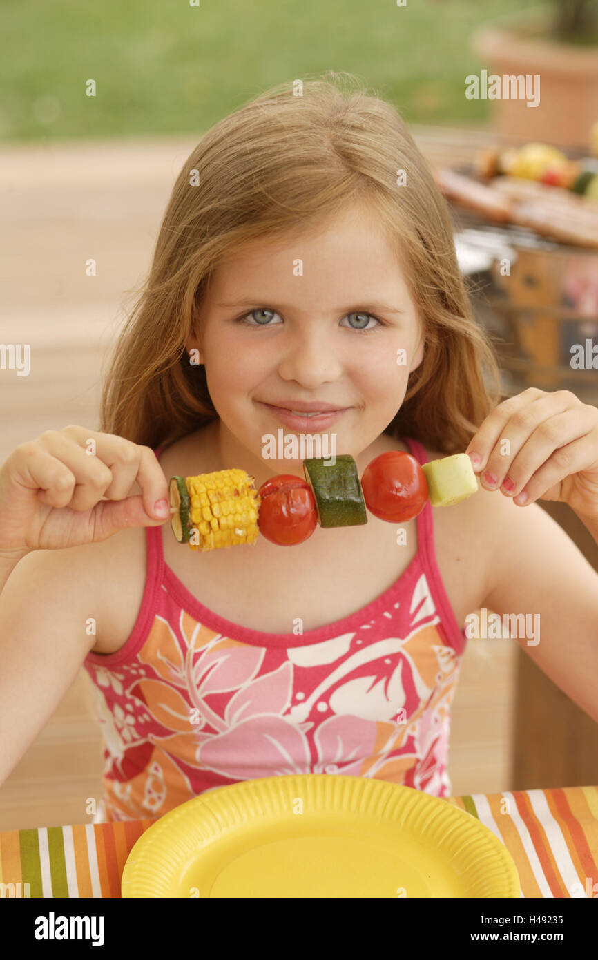 Child, girl, vegetable spit, hold, view camera, smile, outside Stock ...