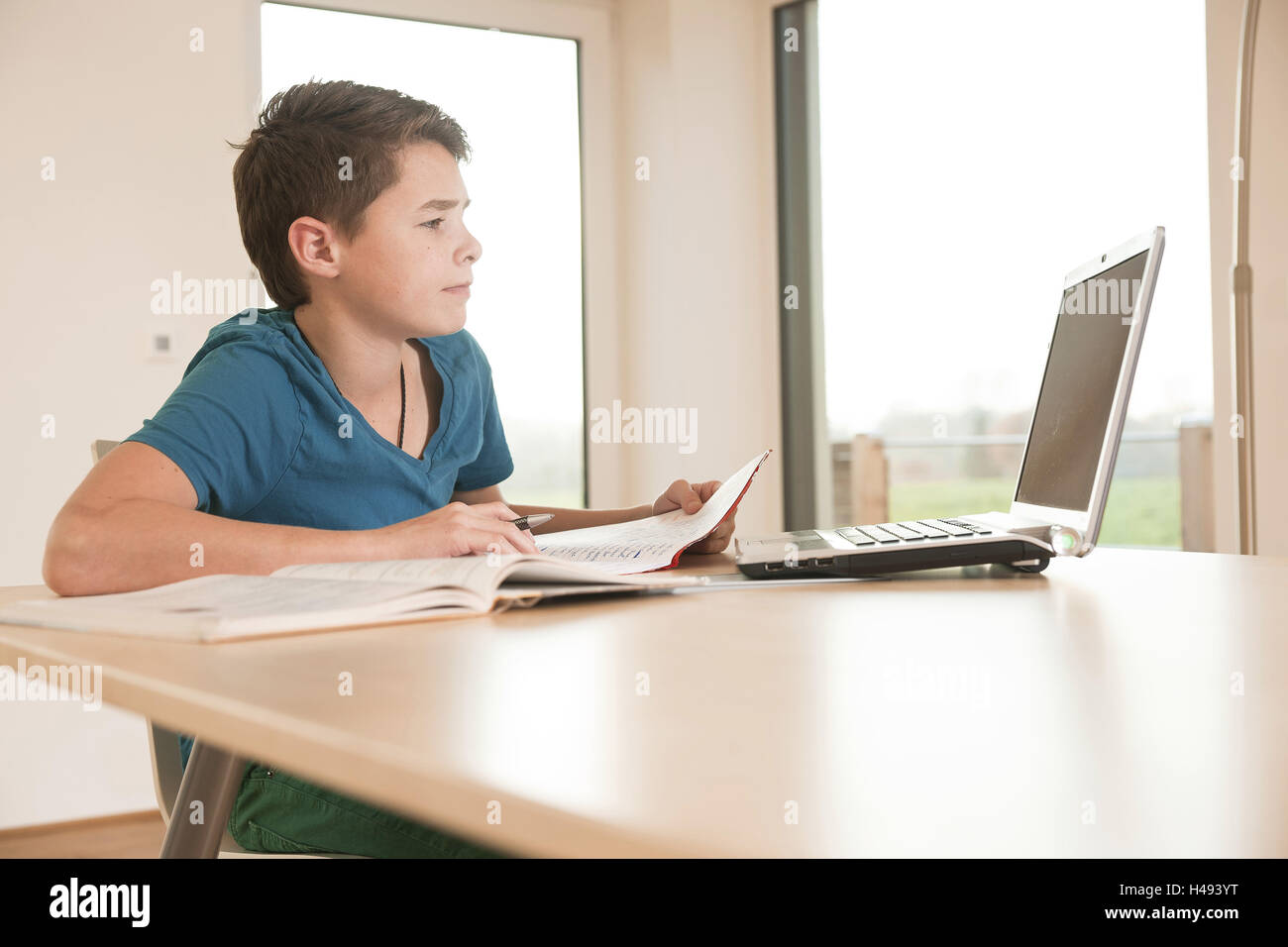 Boy works intently on the computer Stock Photo - Alamy