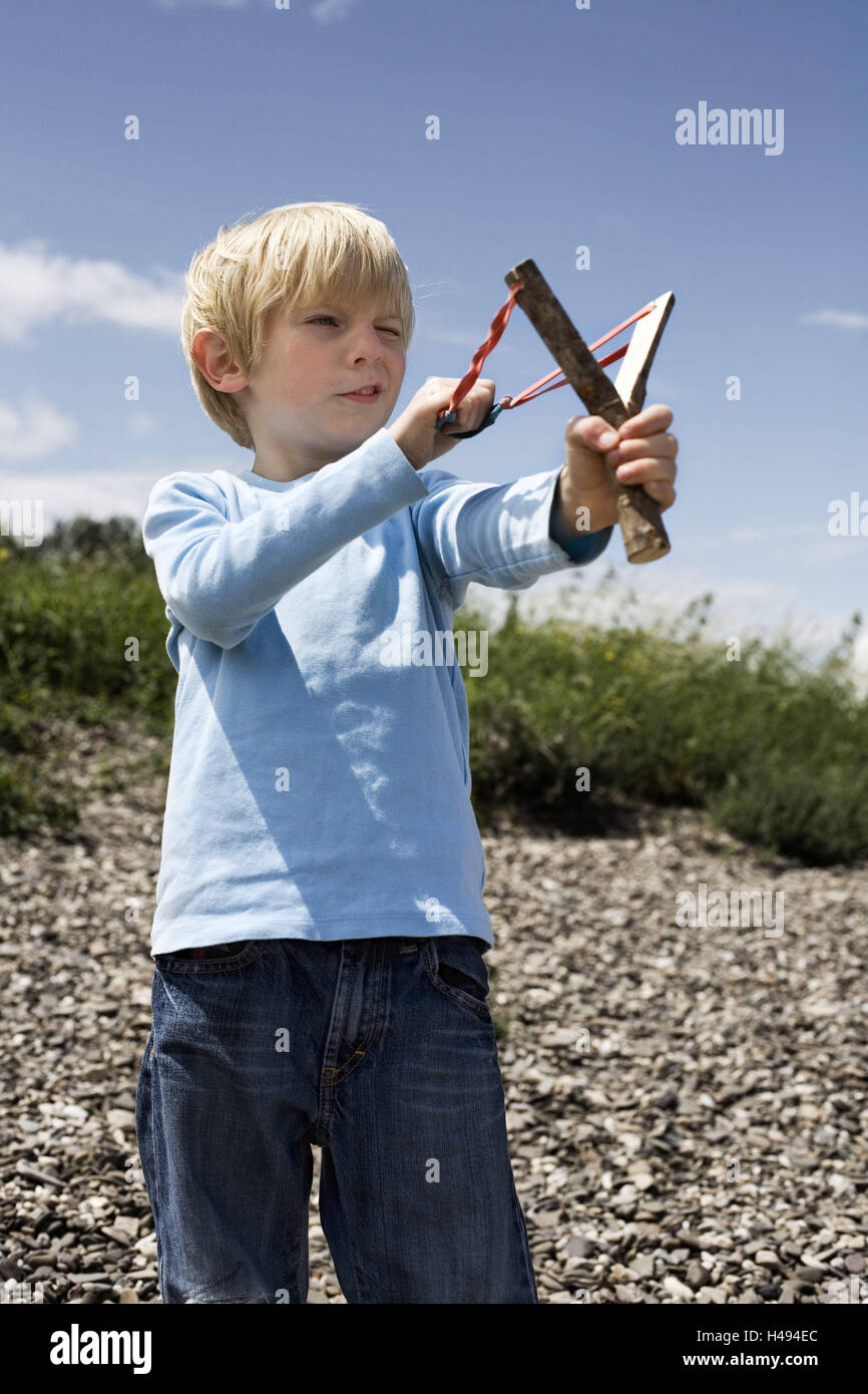 Boy, catapult, aim, steer for Stock Photo - Alamy