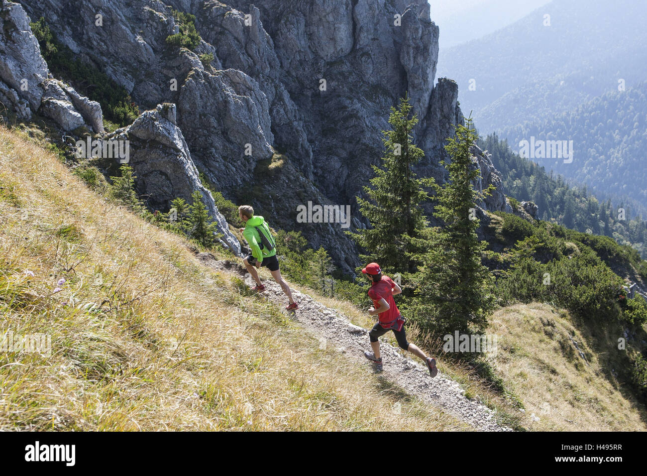 Two young mountain runners on mountain path Stock Photo - Alamy
