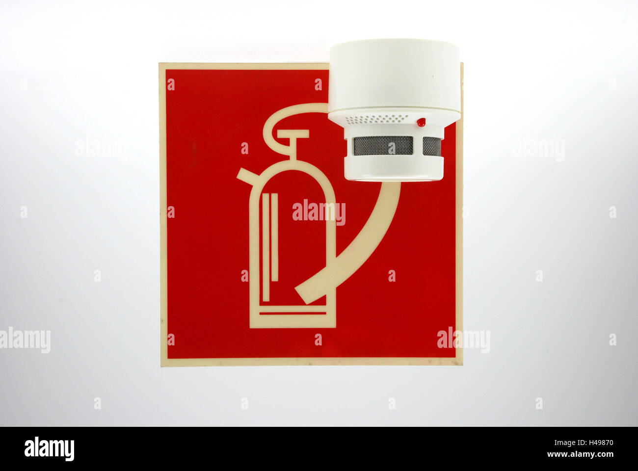 Smoke detector, fire extinguisher, tip notice board Stock Photo - Alamy
