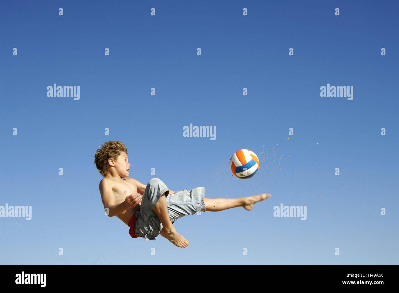 Boy, play ball, leap Stock Photo - Alamy