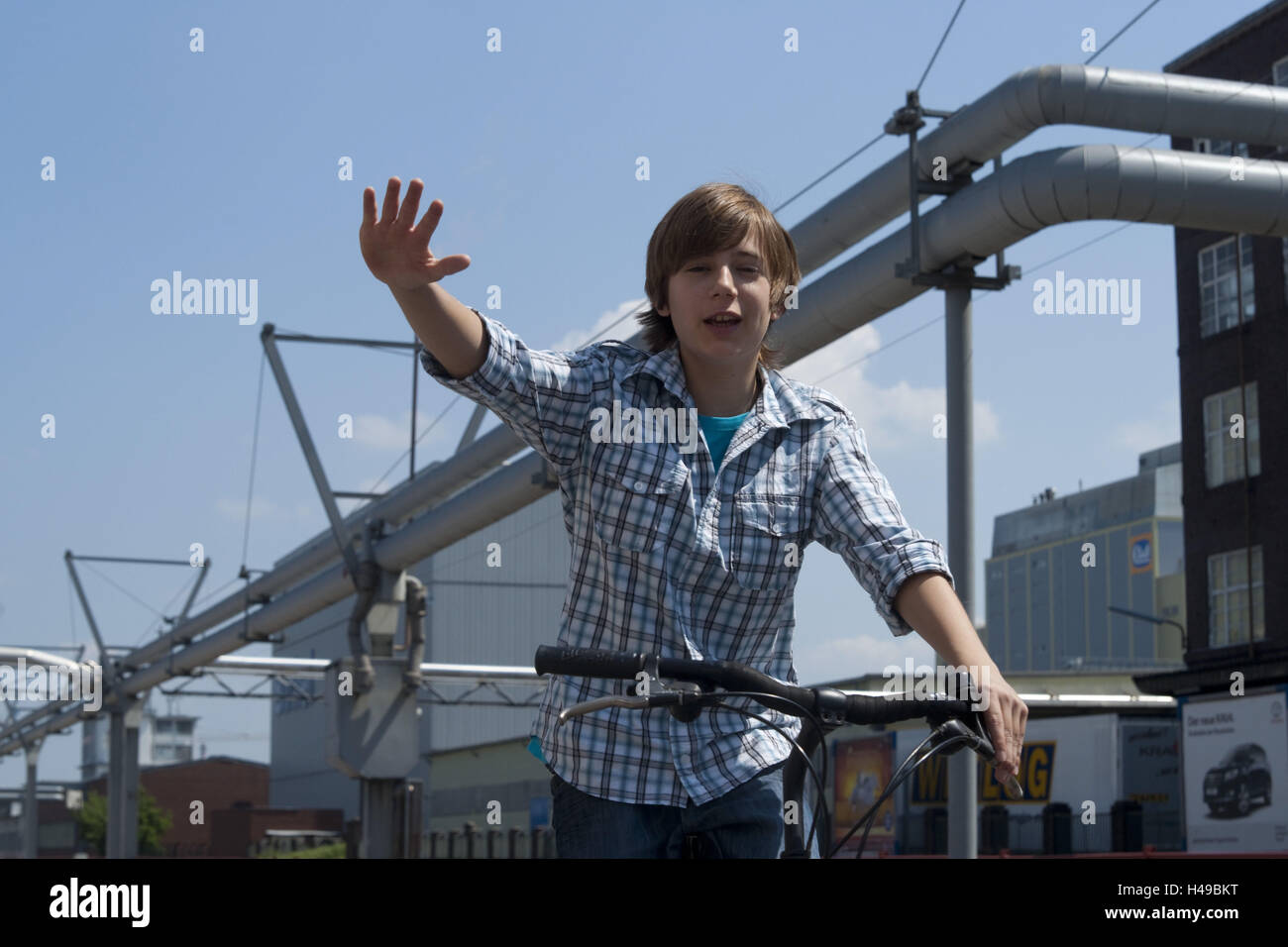 Teenager boy, outstretched hand, bicycle driving Stock Photo - Alamy