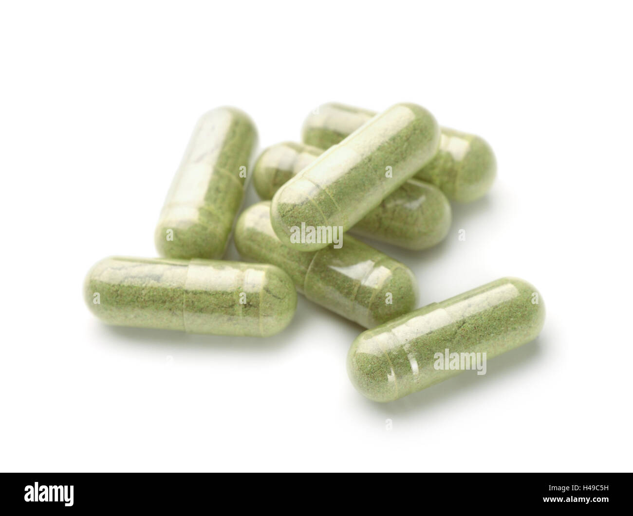 Herbal medicine capsules isolated on white Stock Photo - Alamy