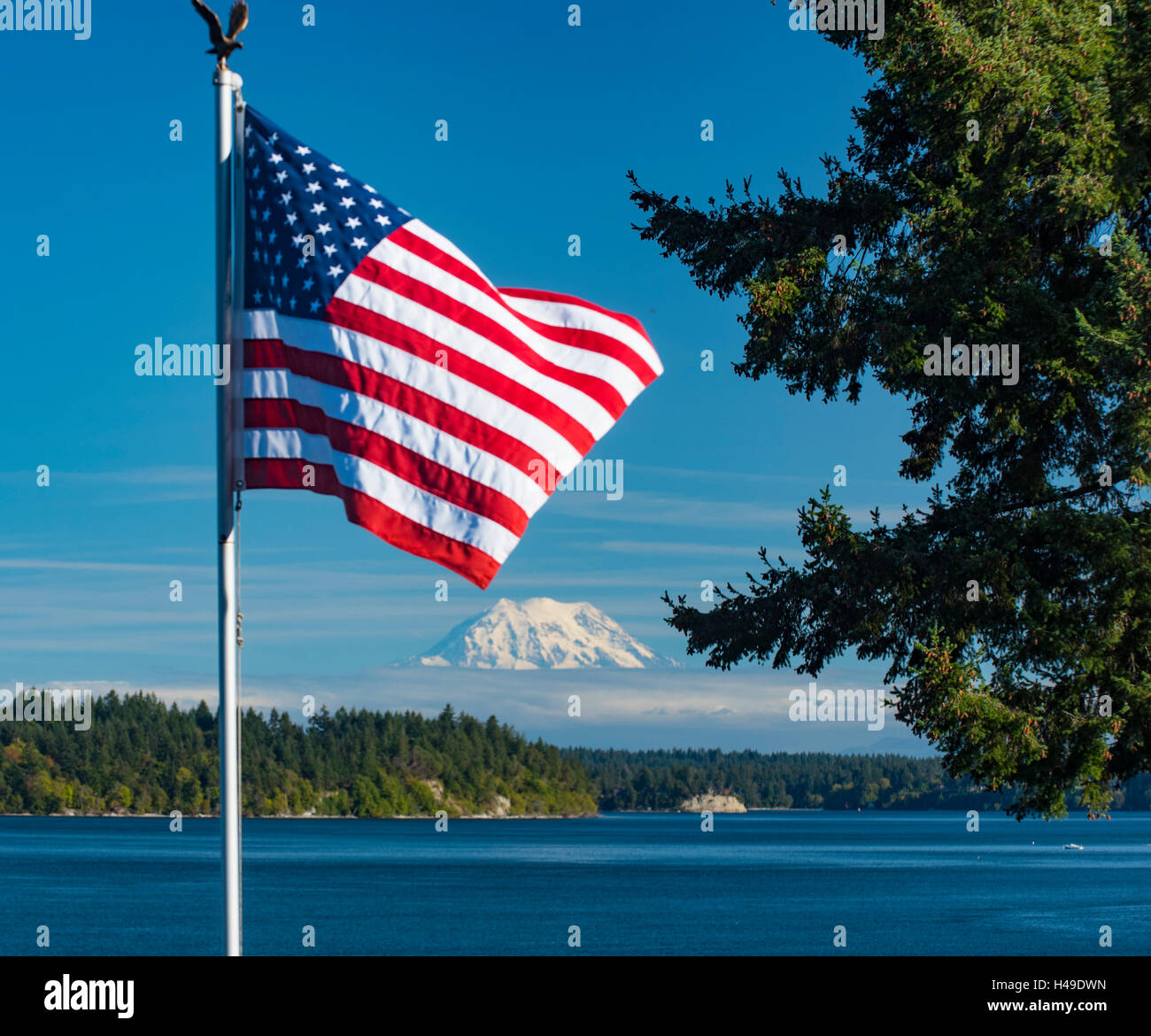American Flag flying on flag pole with Mt. Rainier and Puget sound in ...