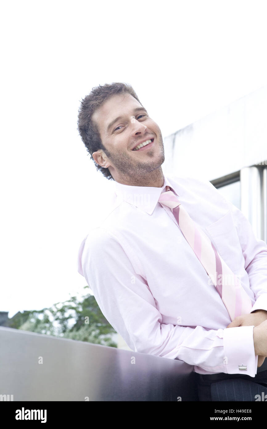 Man, young, smile, lean, railing, half portrait, balcony, terrace ...