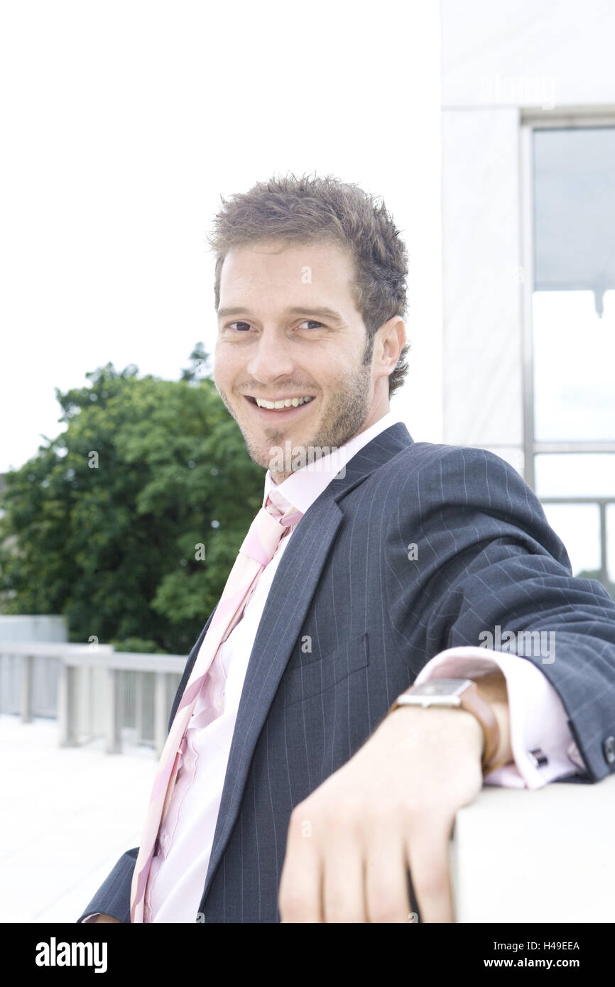 Man, young, smile, lean, railing, half portrait, balcony, terrace ...