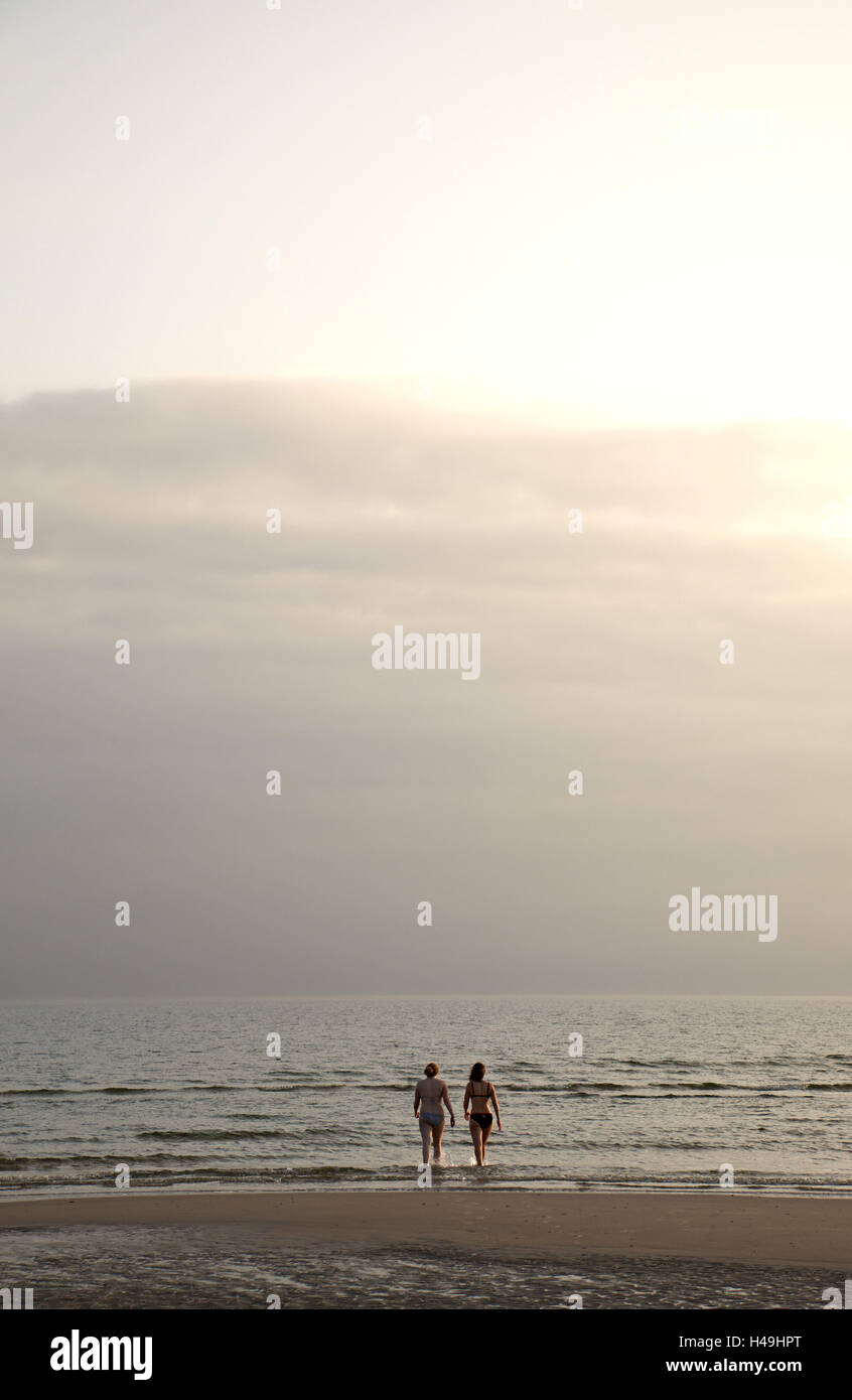 Beach, sea, two women, have a bath, back view Stock Photo - Alamy