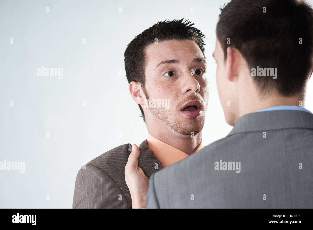young businesmen face arguing Stock Photo - Alamy