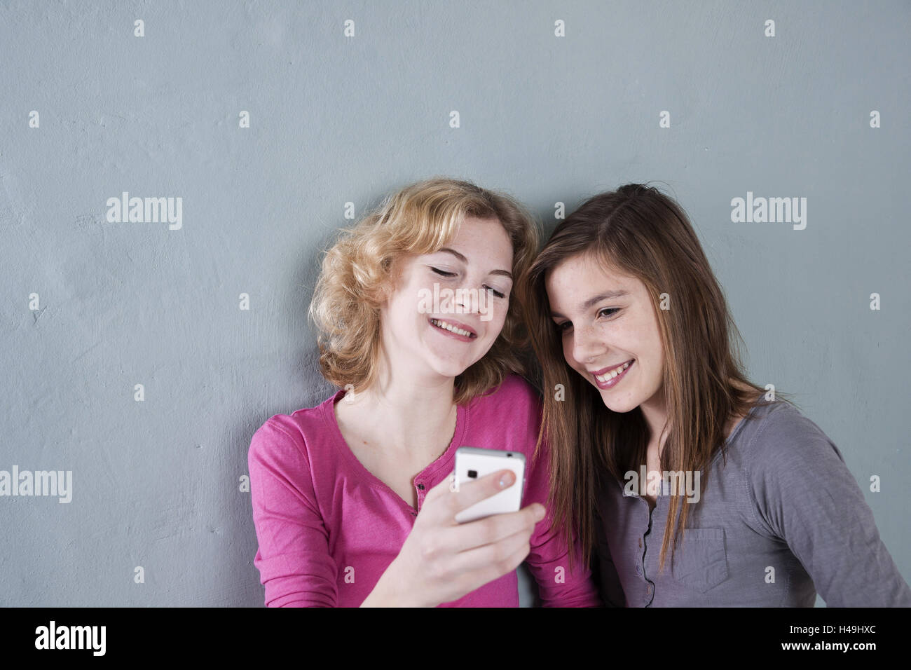 Two girls with mobile phone Stock Photo - Alamy