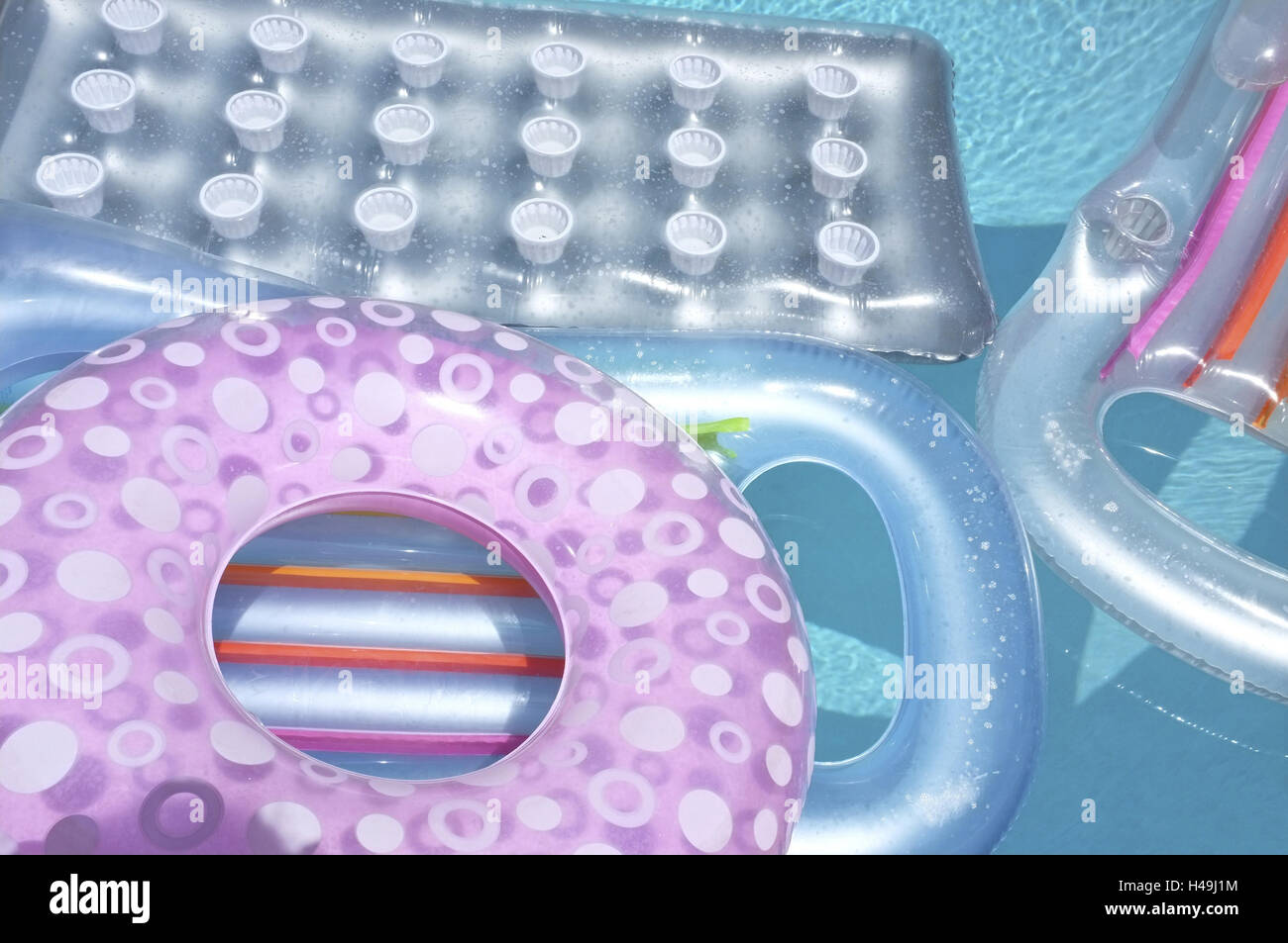 Pool, floating tyre, air beds Stock Photo - Alamy
