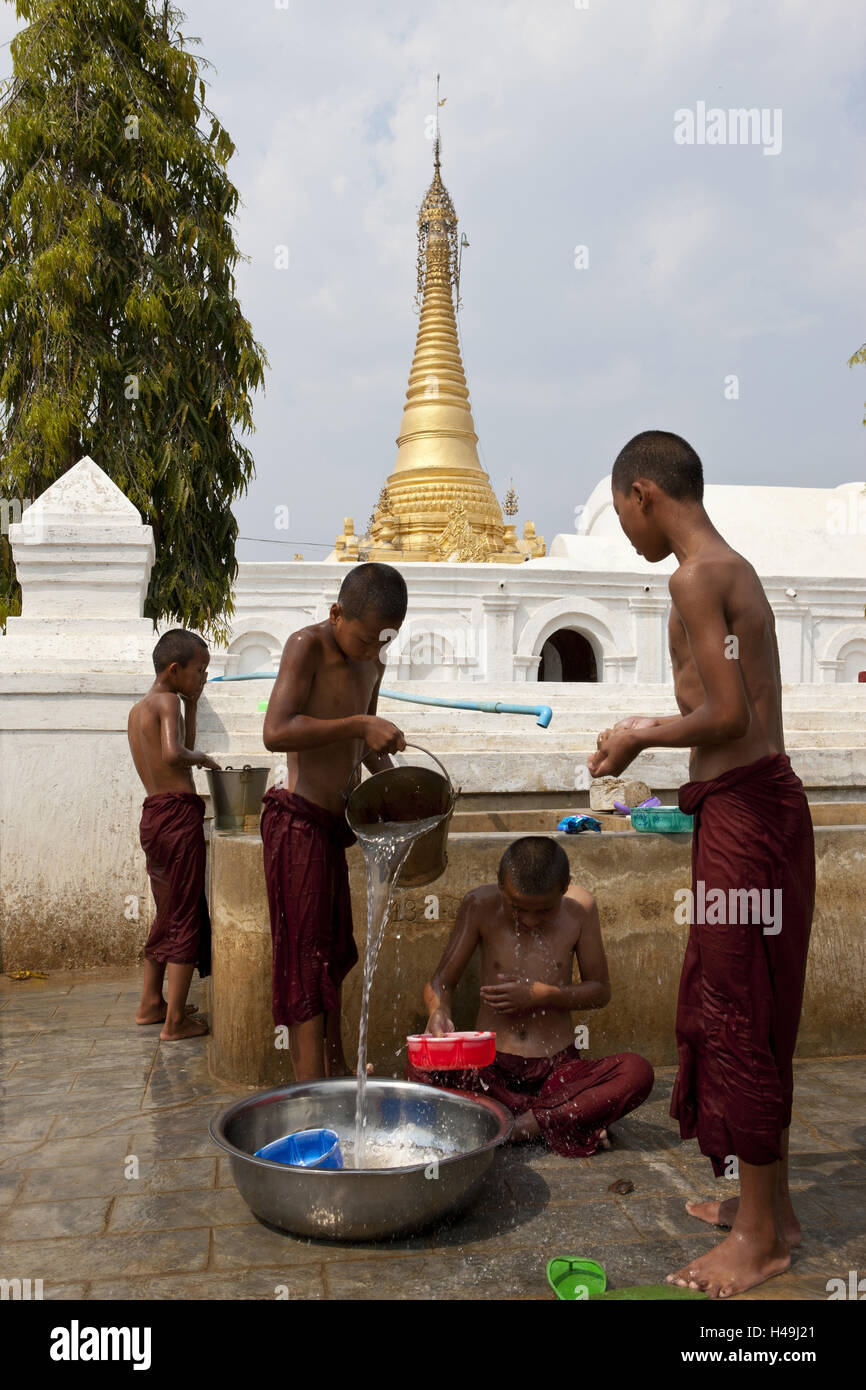 Myanmar, Shan state, region Inle lake, Nyaung Shwe, young monks wash ...