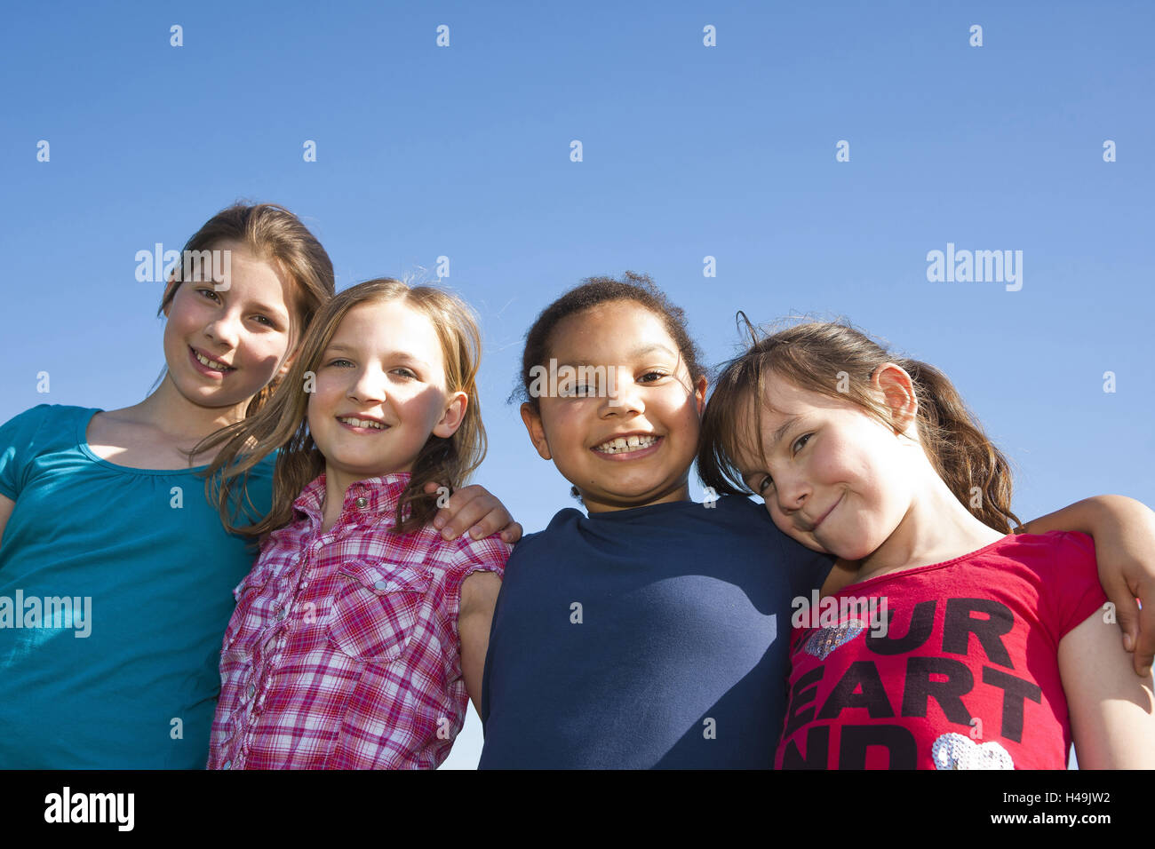 four girls, arm in arm, smile, outside, portrait, view camera Stock ...