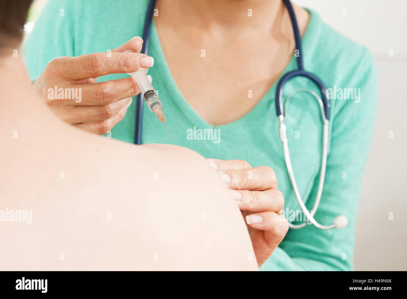 Teenager receives an injection Stock Photo - Alamy