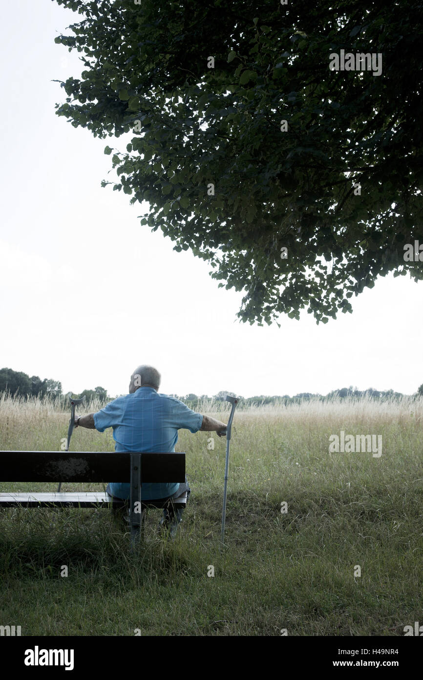 Senior sitting alone on a bench Stock Photo - Alamy
